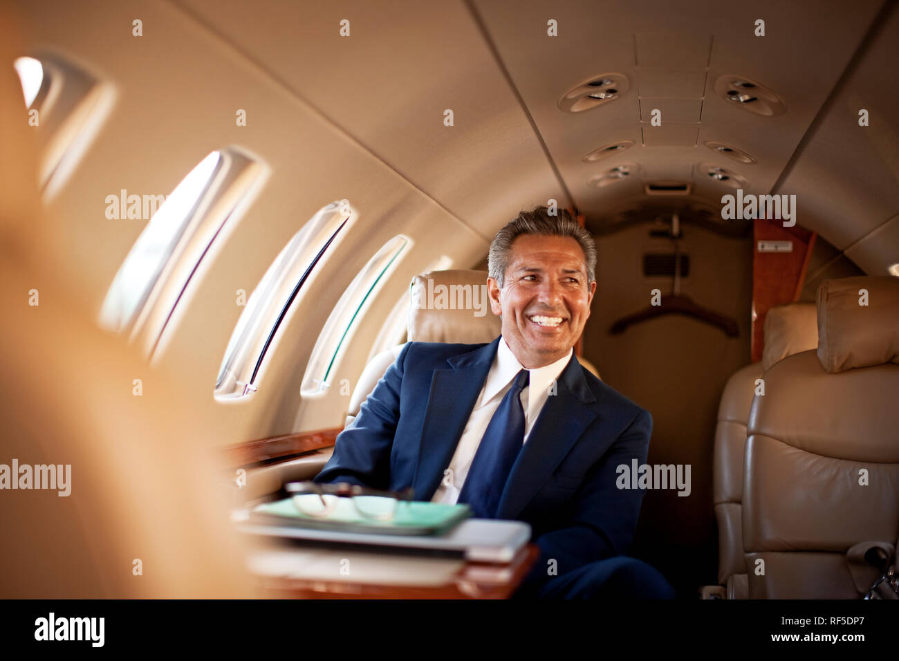 Businessman smiling inside airplane hi-res stock photography and images ...