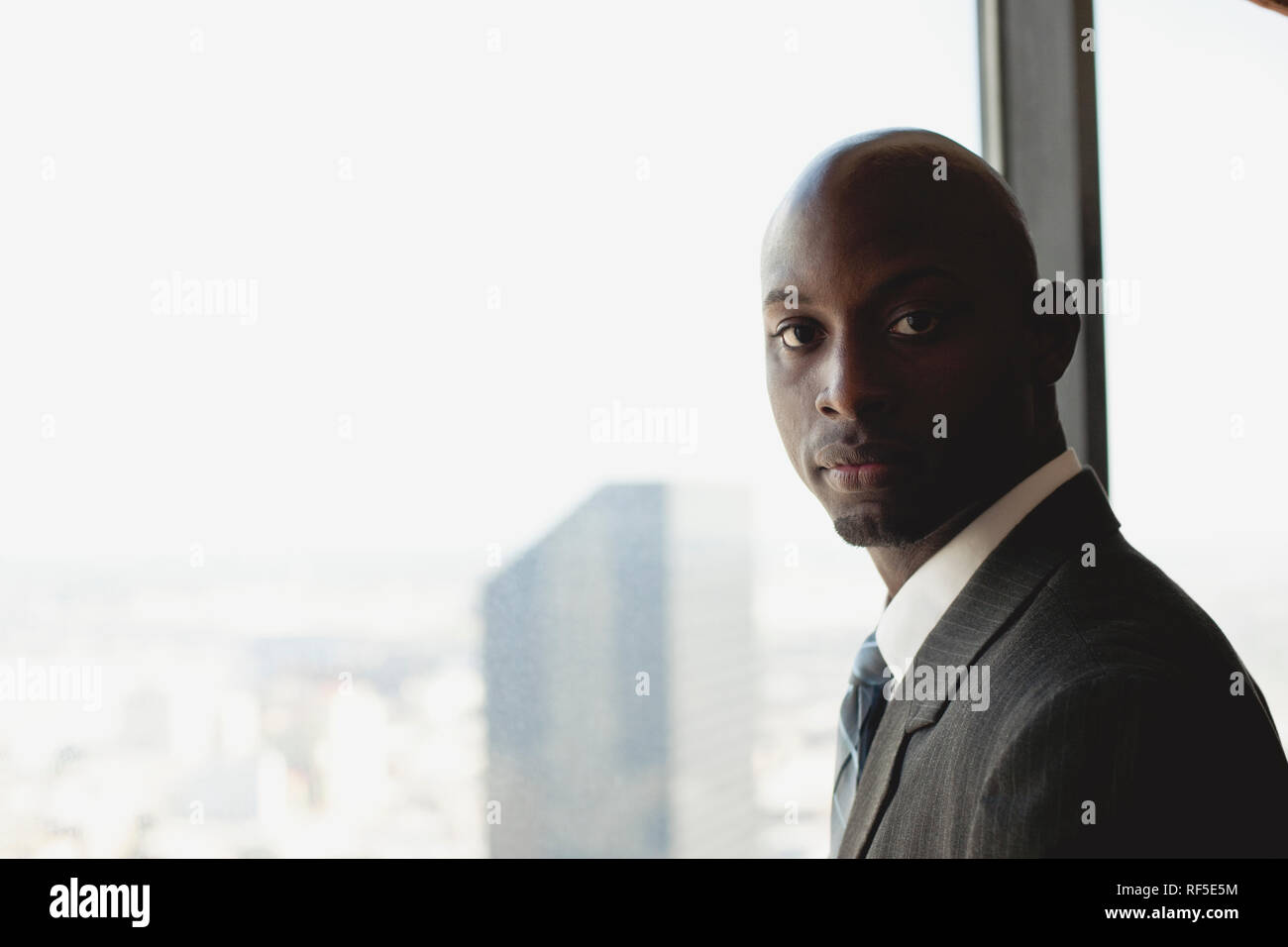 Man standing beside window Stock Photo - Alamy