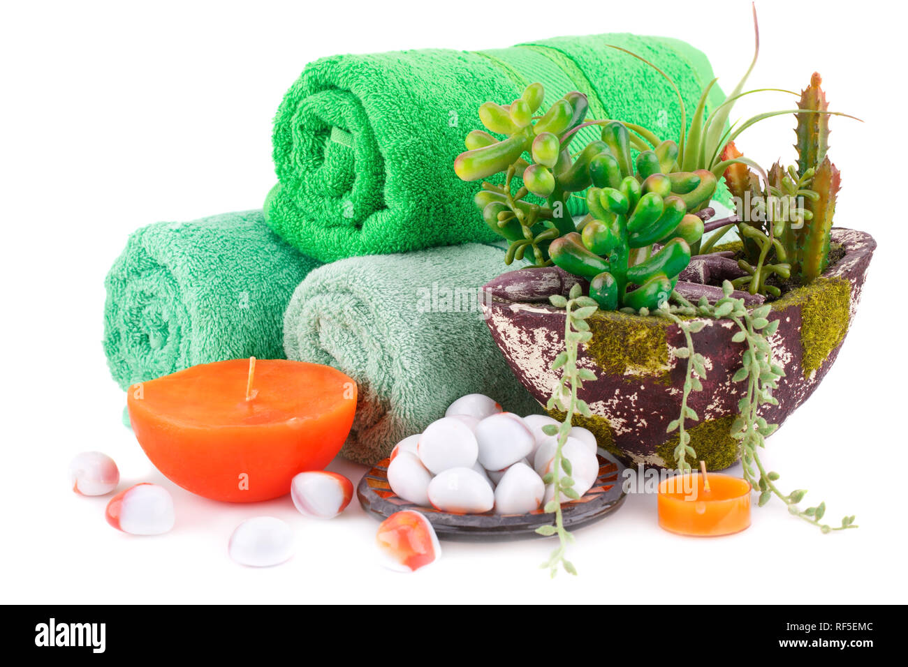 Spa set with towels, candles and plant in vase isolated on white ...