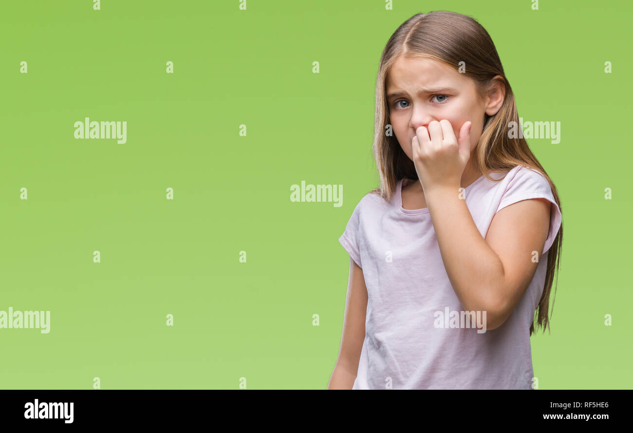 Young beautiful girl over isolated background looking stressed and ...