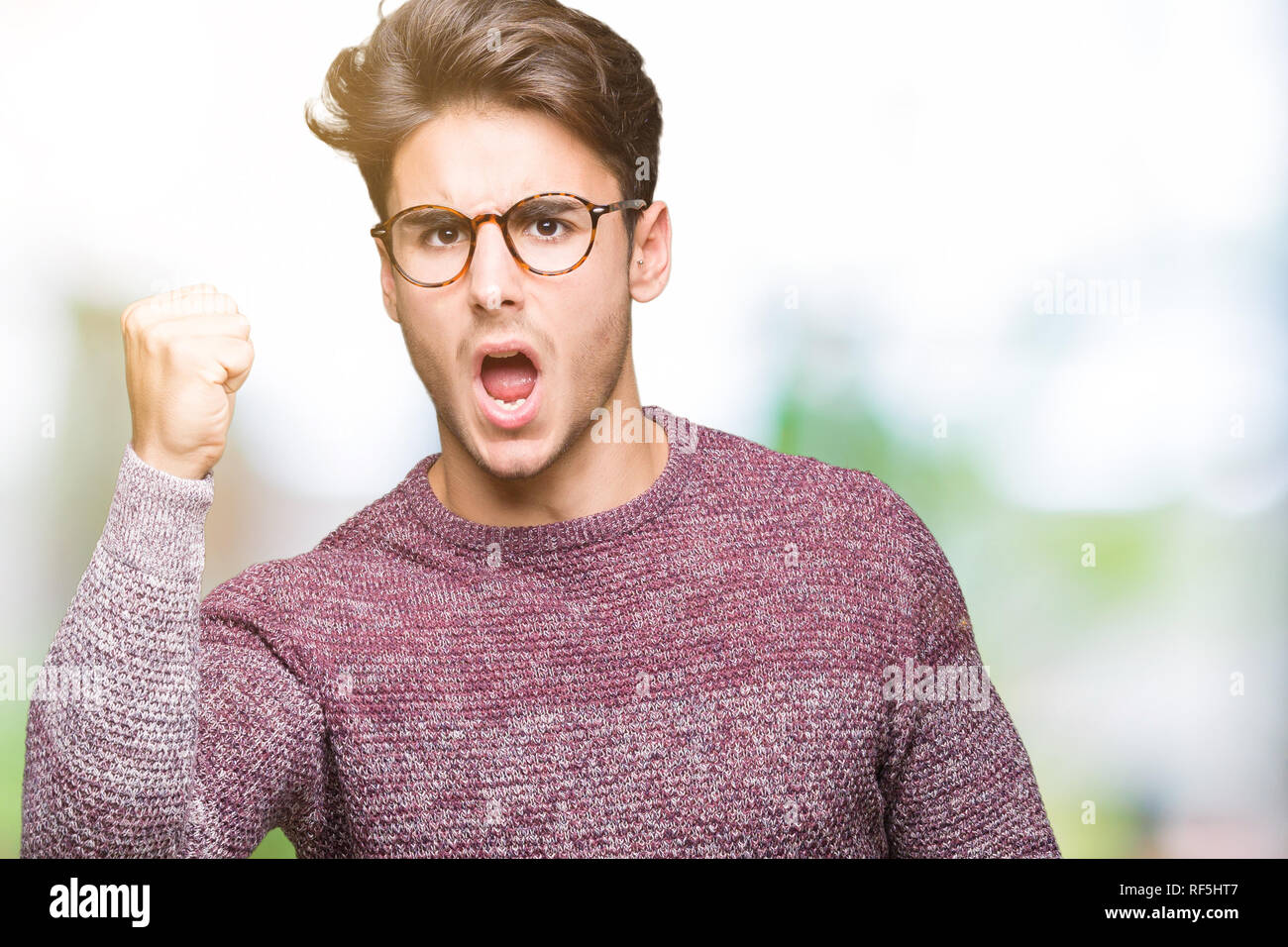 Young handsome man wearing glasses over isolated background angry and ...