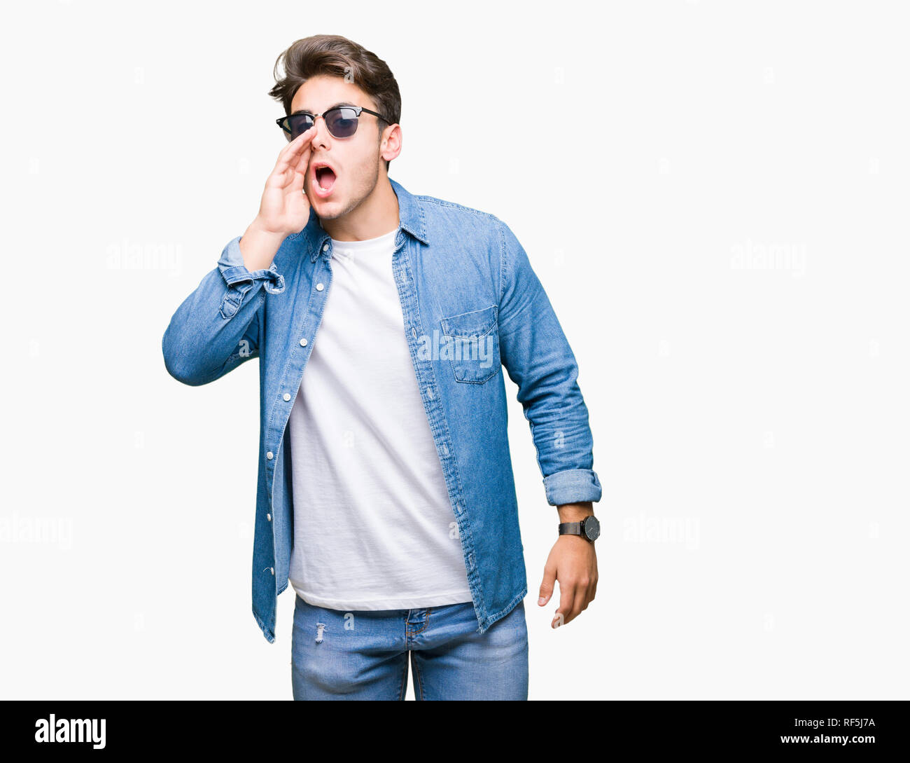Young handsome man wearing sunglasses over isolated background shouting ...