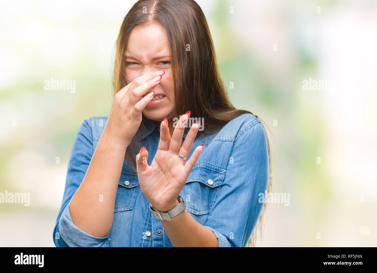Young caucasian beautiful woman over isolated background smelling ...
