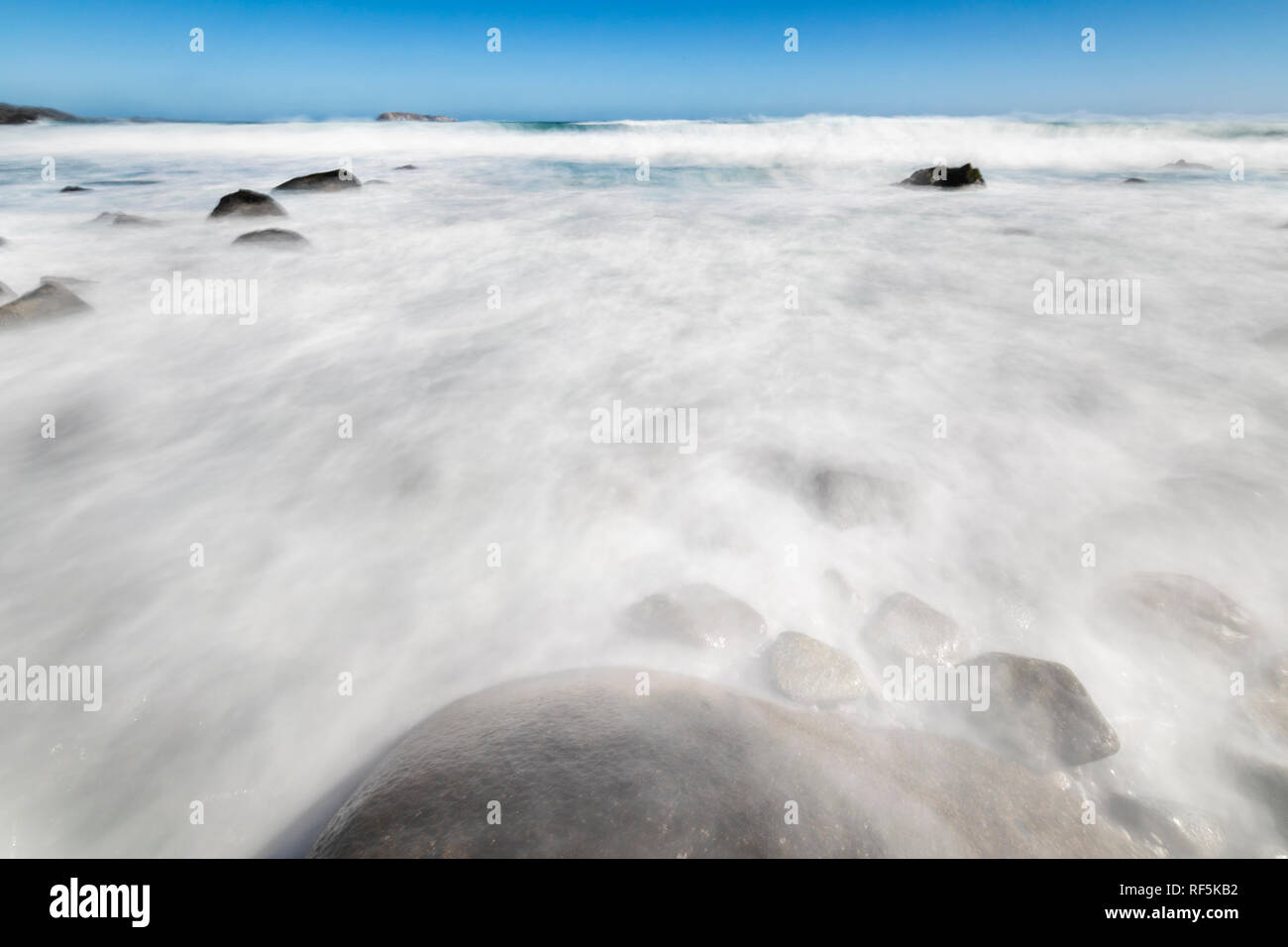 The water moving in between the rocks at a wild beach in Atacama Desert ...