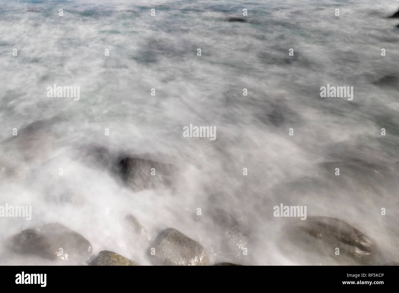 The water moving in between the rocks at a wild beach in Atacama Desert ...