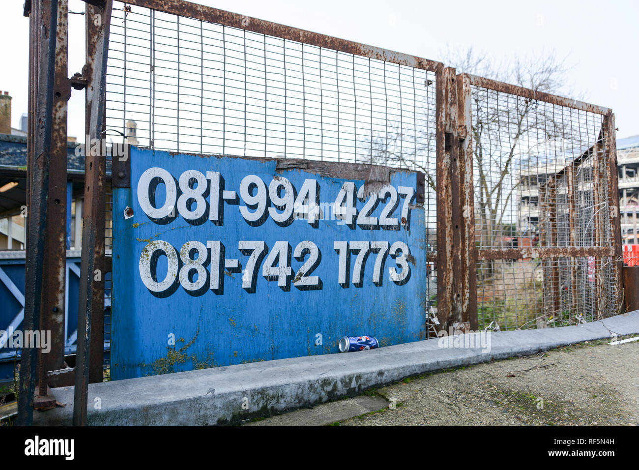 Old 081 London telephone numbers on a wrought iron gate in Brentford ...