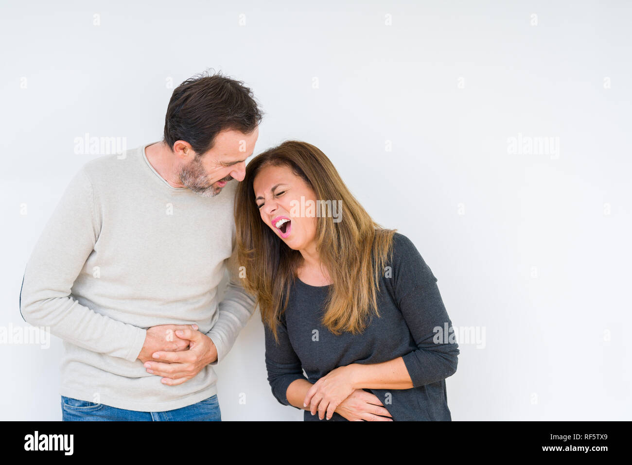 Beautiful middle age couple in love over isolated background with hand ...