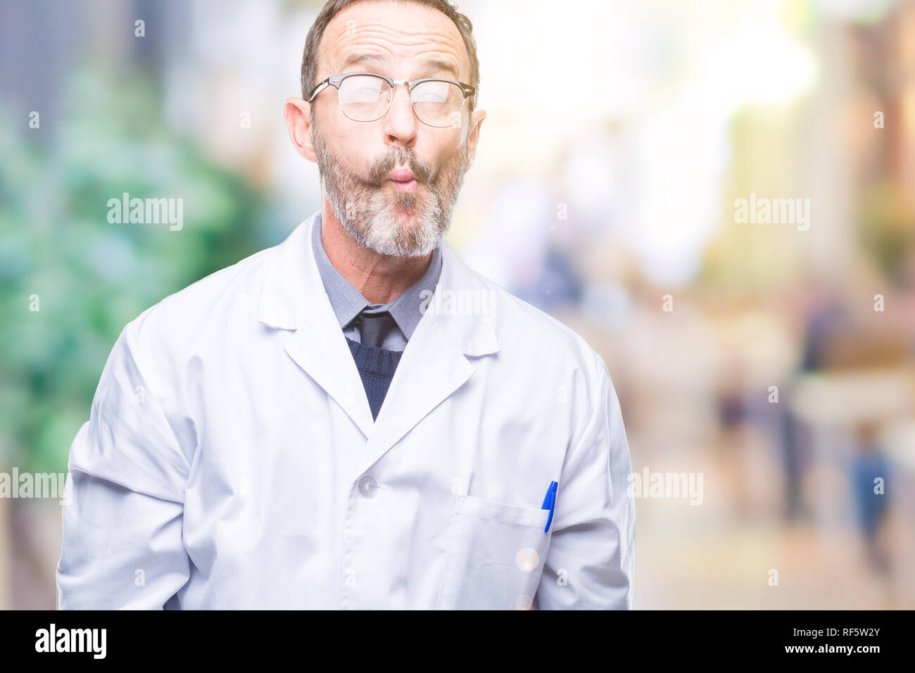Middle age senior hoary professional man wearing white coat over ...