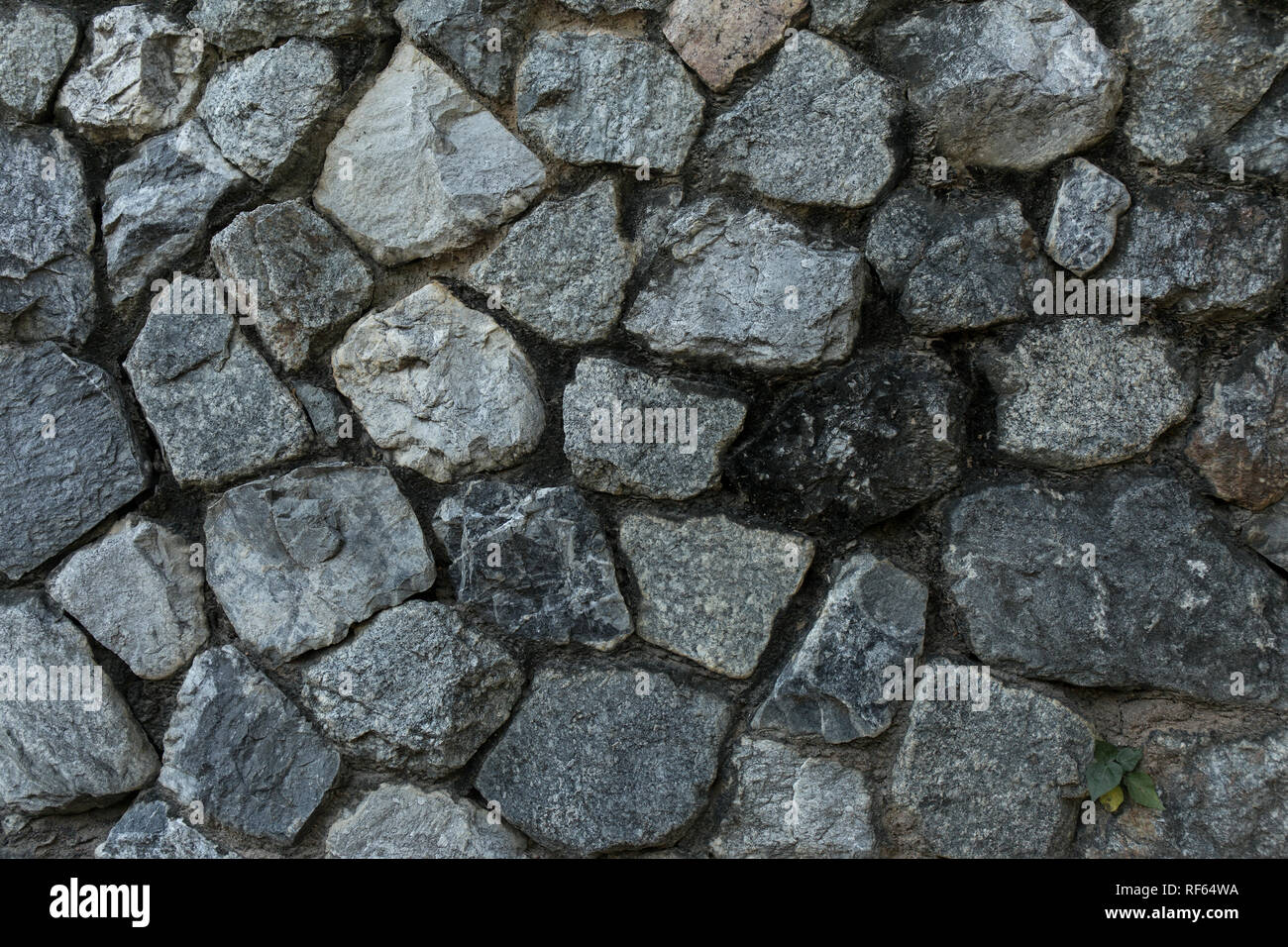 Old rough stone wall. Rock gray background Stock Photo - Alamy