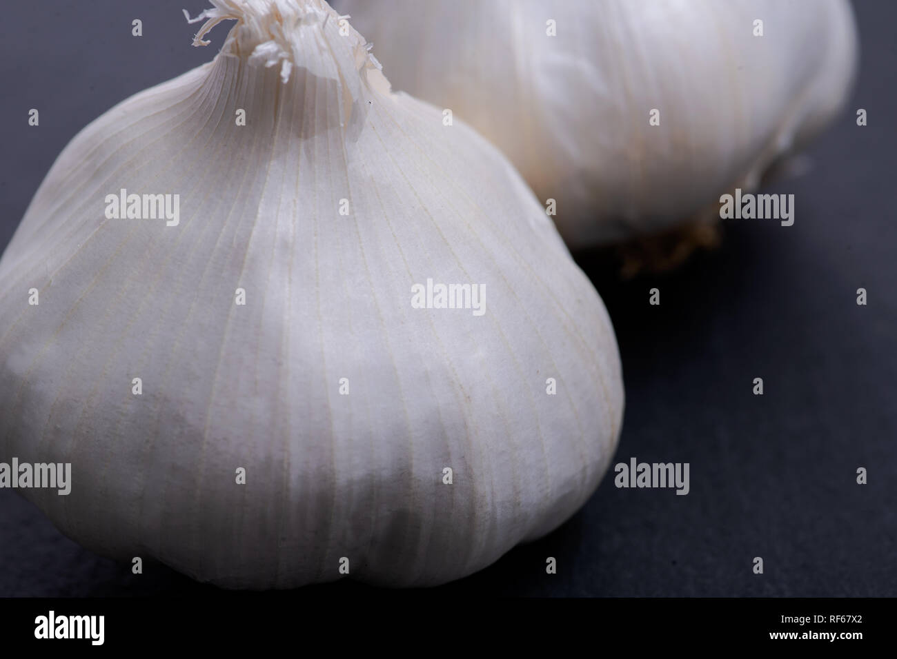Fresh ripe organic garlic on natural stone background Stock Photo - Alamy