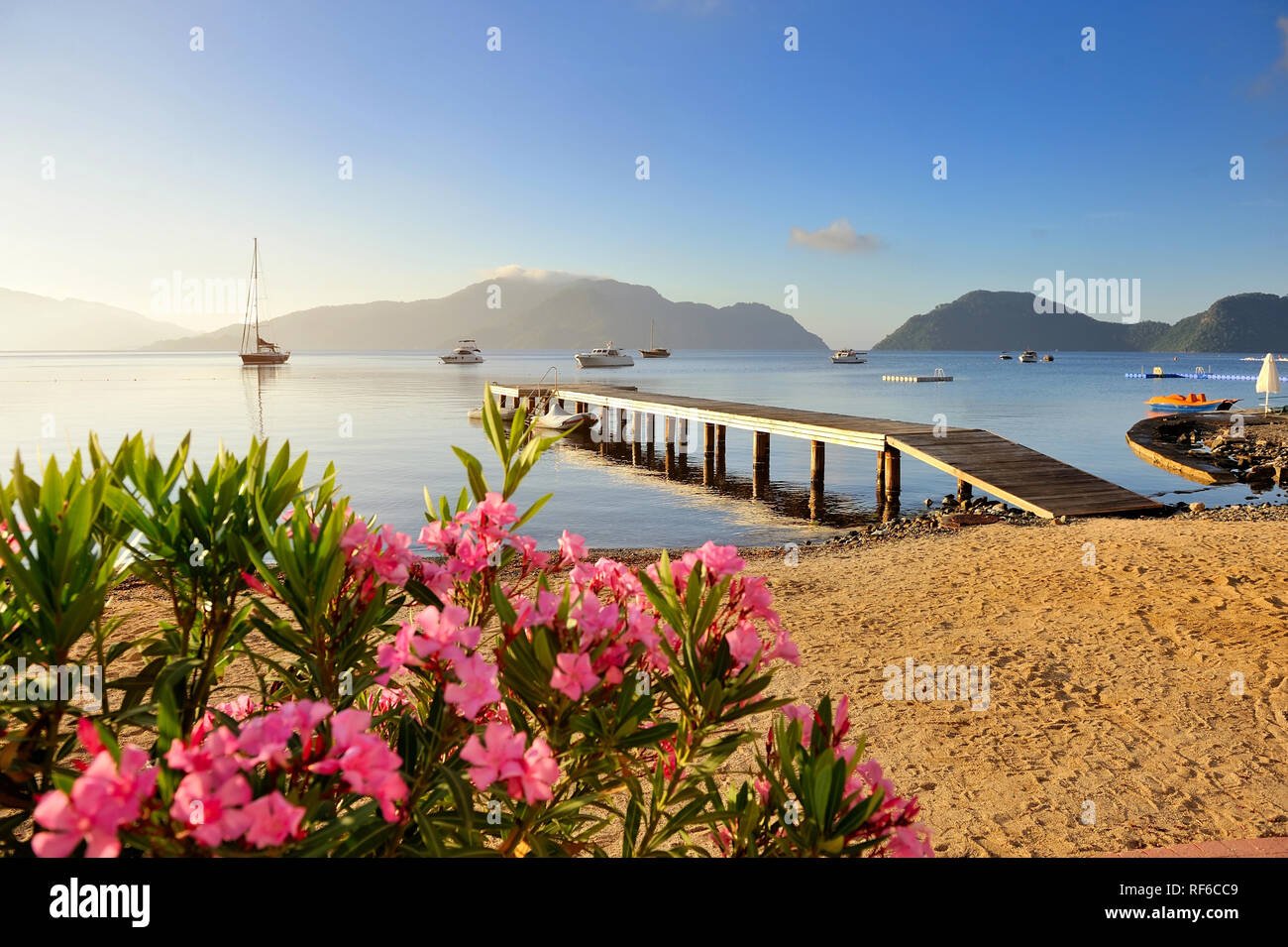 Morning seascape with pier and boats Stock Photo - Alamy