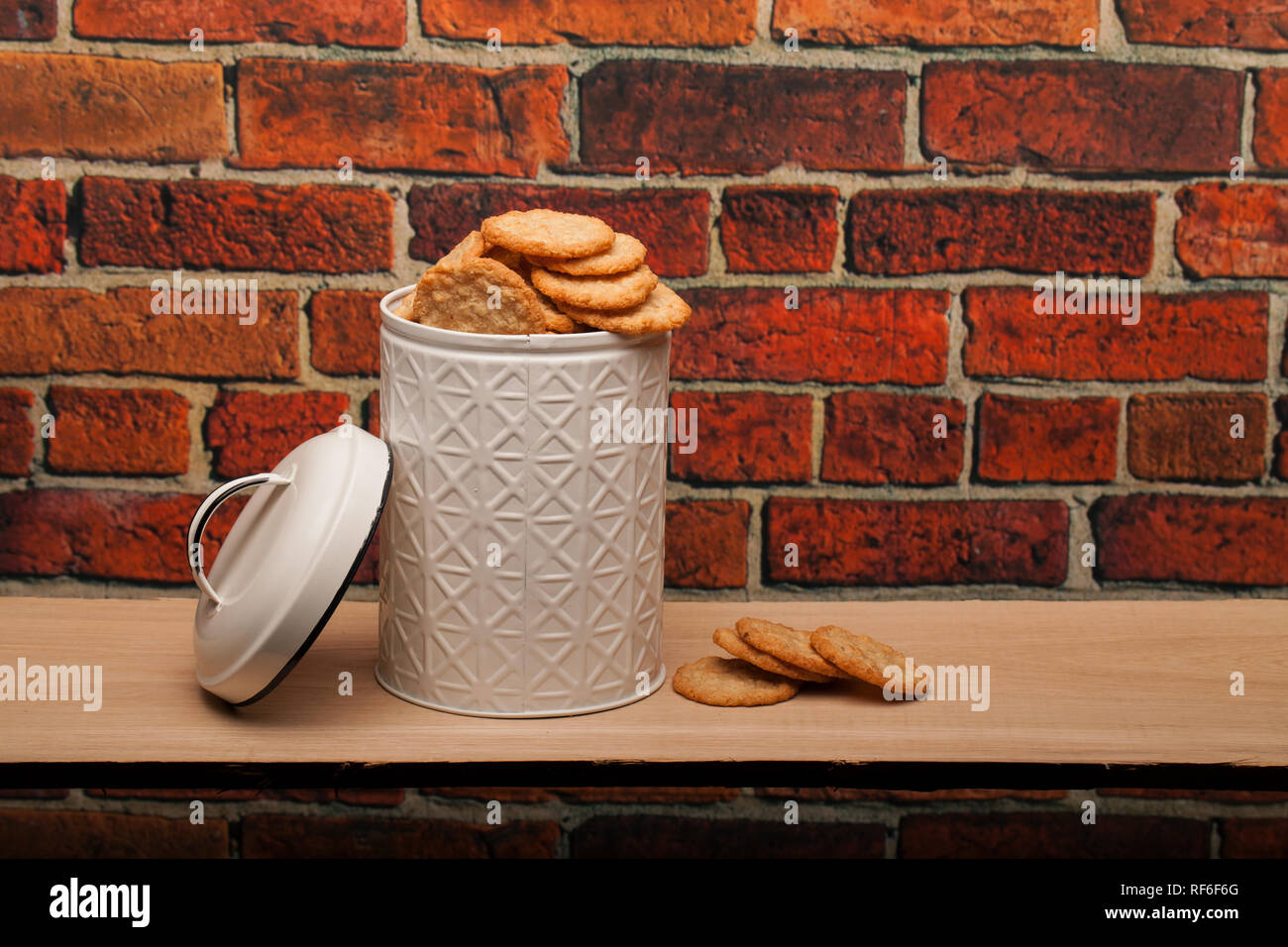 Oatmeal cookies on the oak table, with brick wall Stock Photo - Alamy