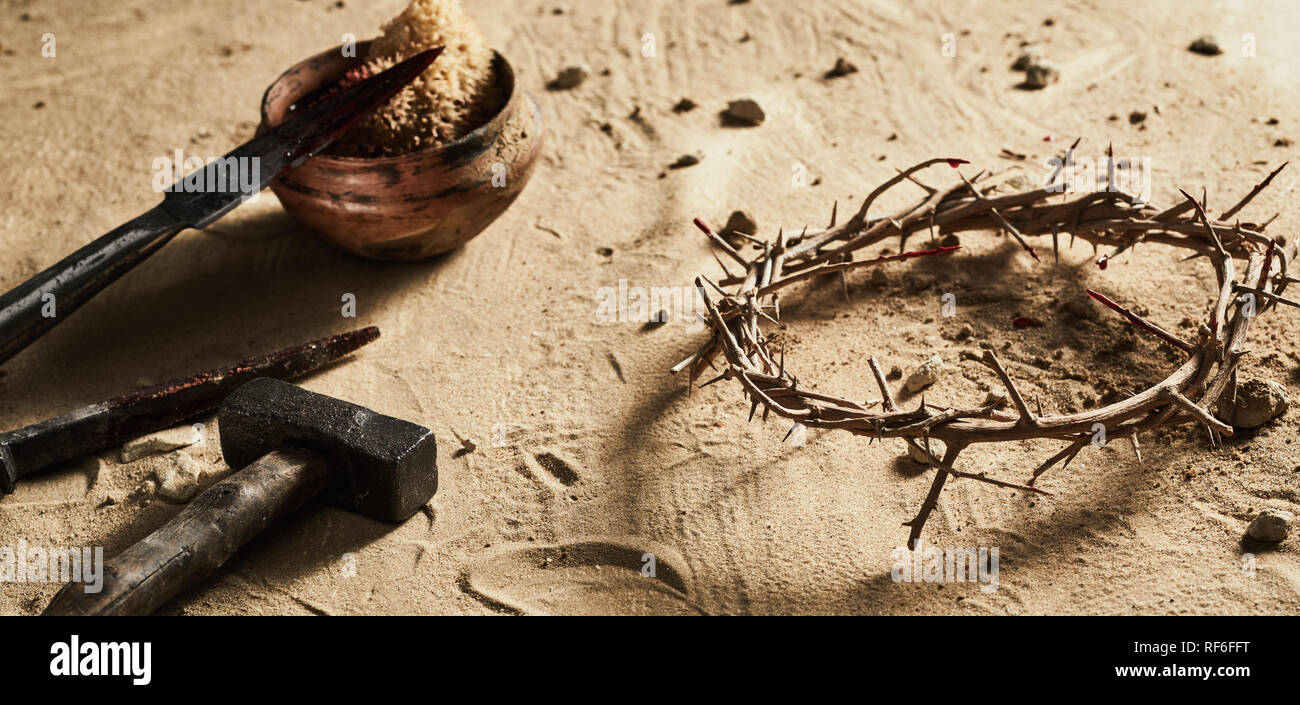 Natural crown of thorns with bloody sponge, spear, old iron nails and a ...