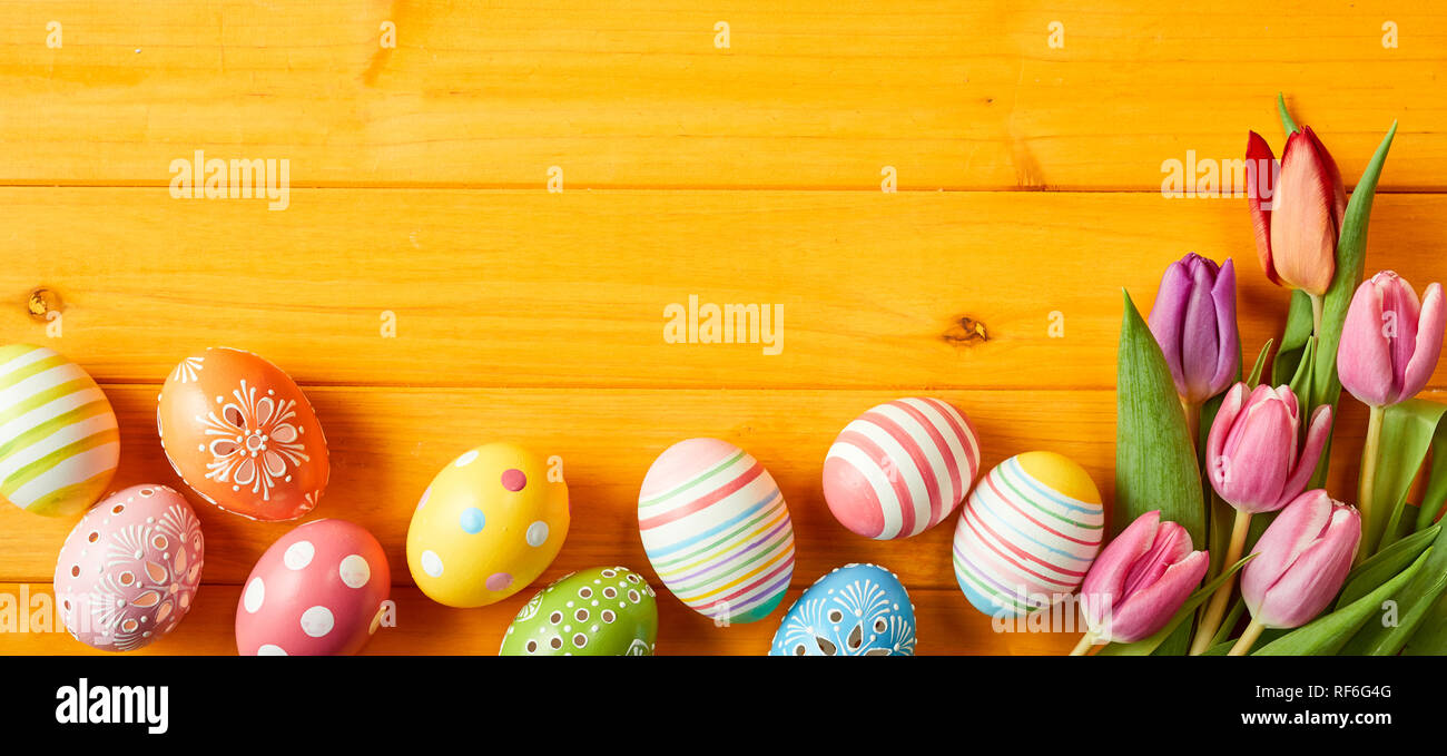 Colorful Easter egg panorama banner with a bouquet of fresh spring ...