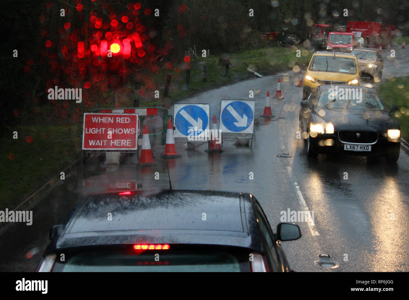Traffic signs and cars in rainy road, UK Stock Photo - Alamy