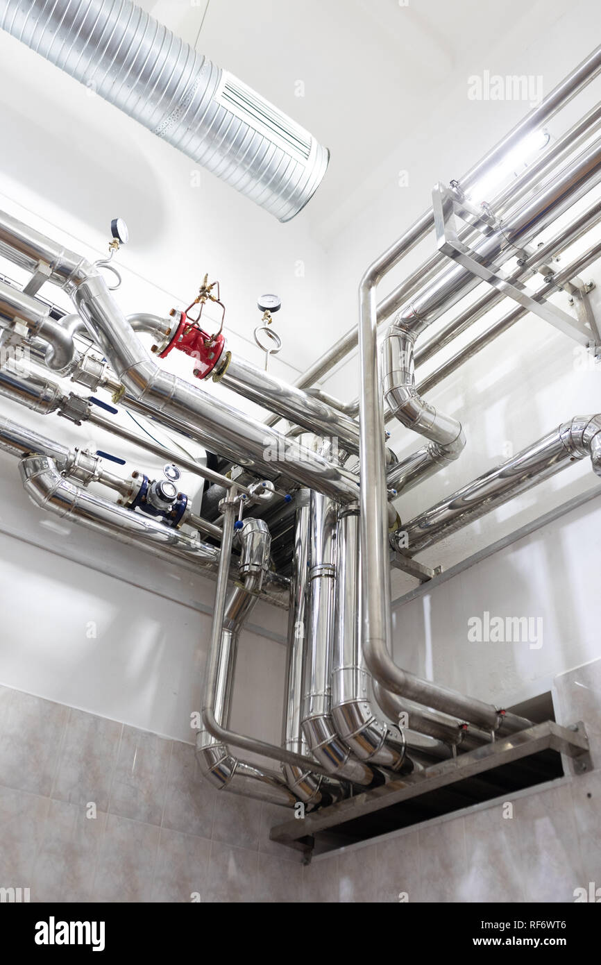 Steel pipelines and cables in factory interior as industrial zone ...