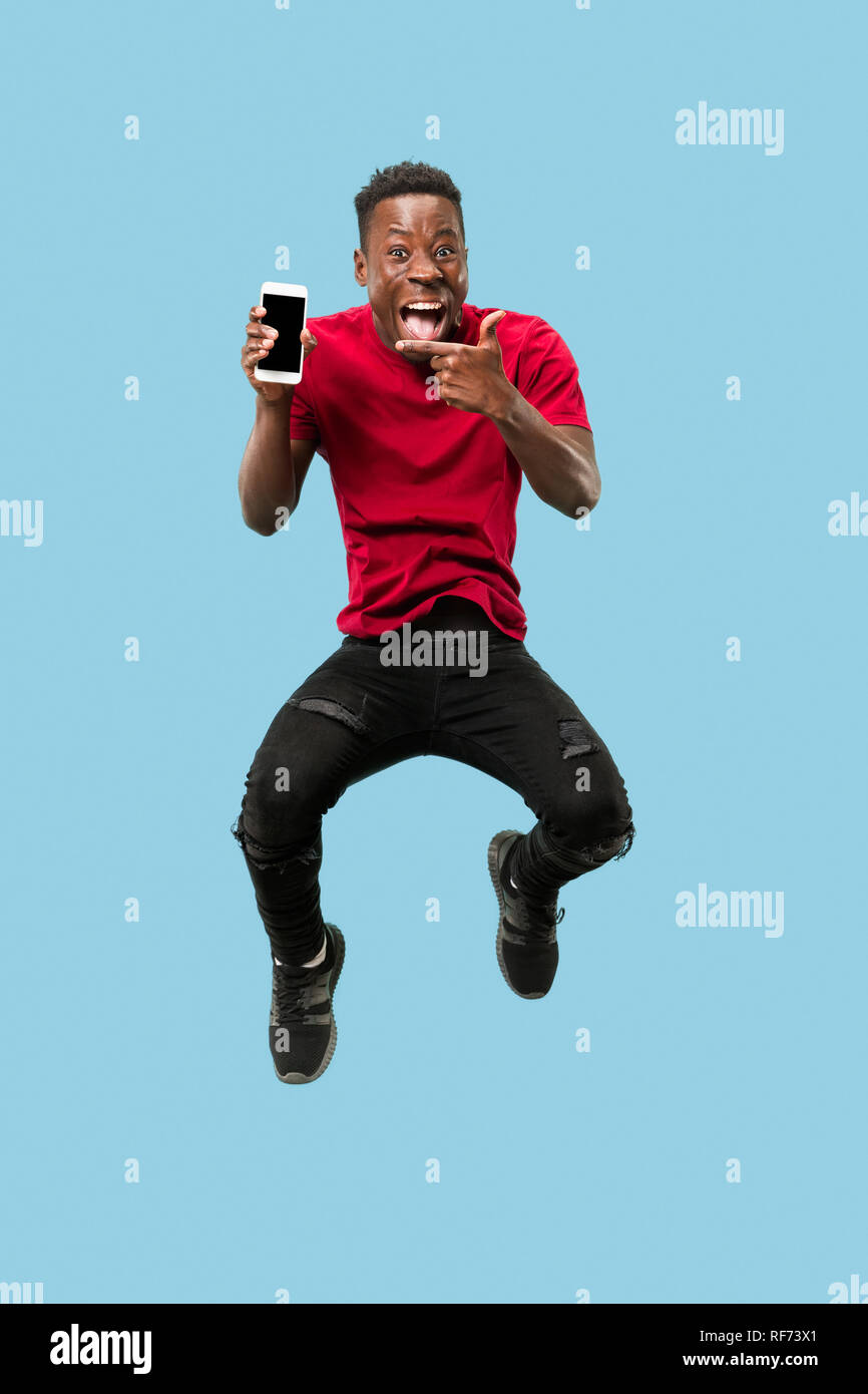 always on mobile. Full length of handsome african young man taking ...