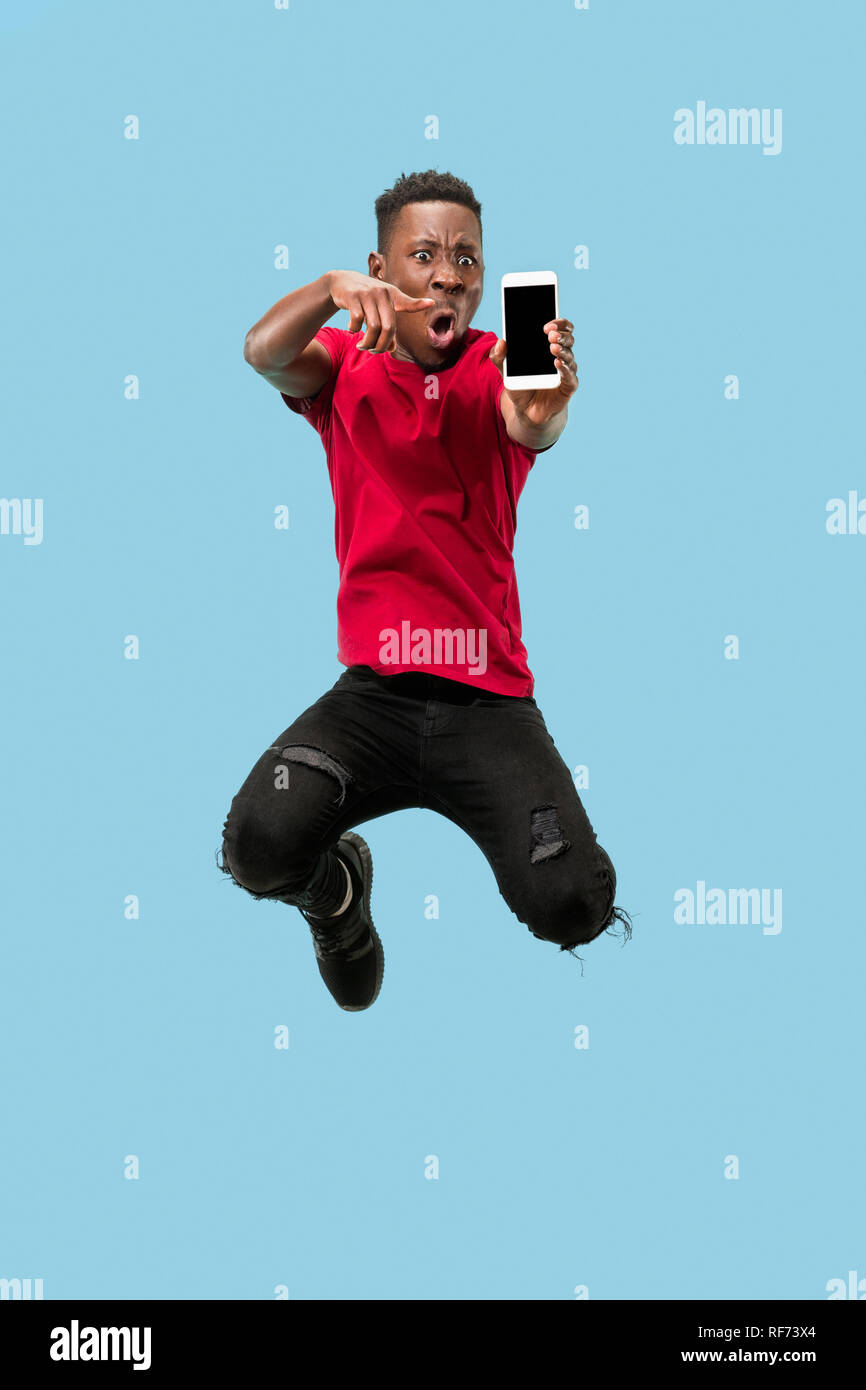 always on mobile. Full length of handsome african young man taking ...