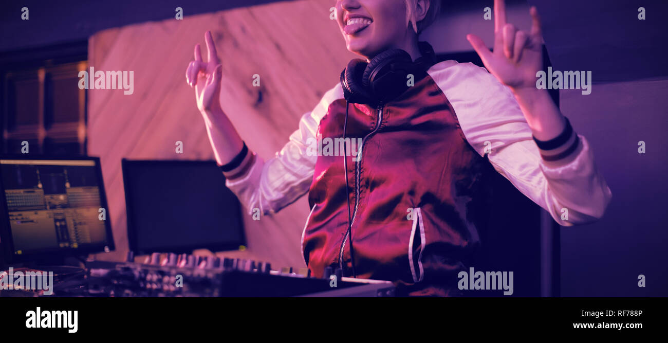 Female dj having fun while playing music in bar Stock Photo - Alamy