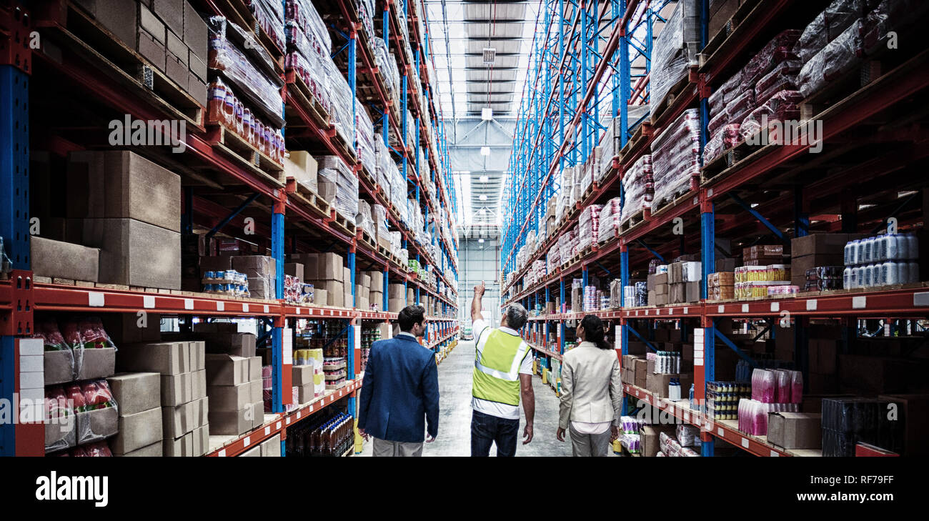 Warehouse team discussing while walking in warehouse Stock Photo - Alamy