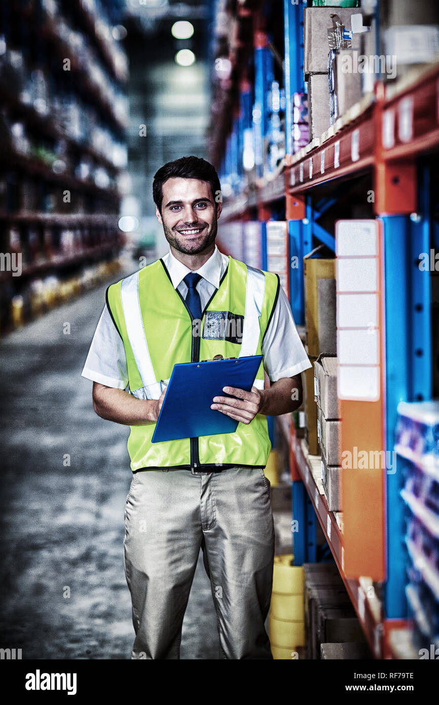 Worker with clipboard looking at camera Stock Photo - Alamy