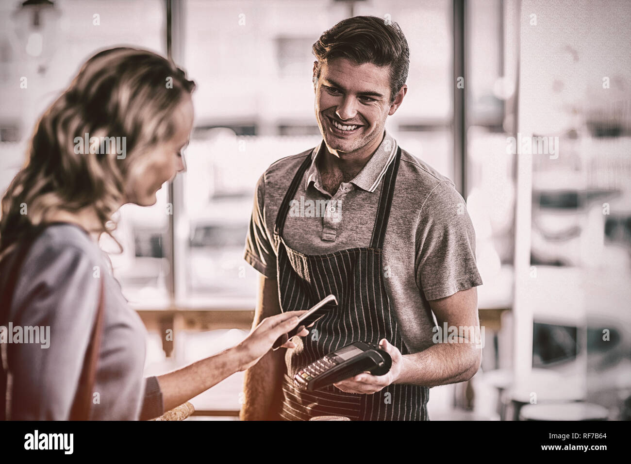 Woman paying bill through smartphone using NFC technology Stock Photo ...