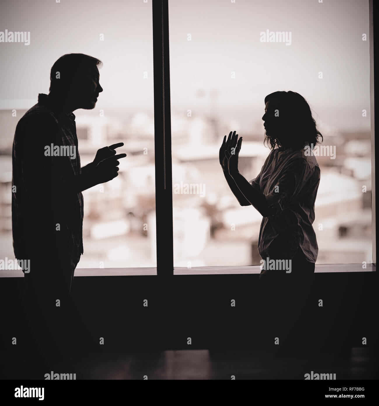 Couple arguing near the window Stock Photo - Alamy