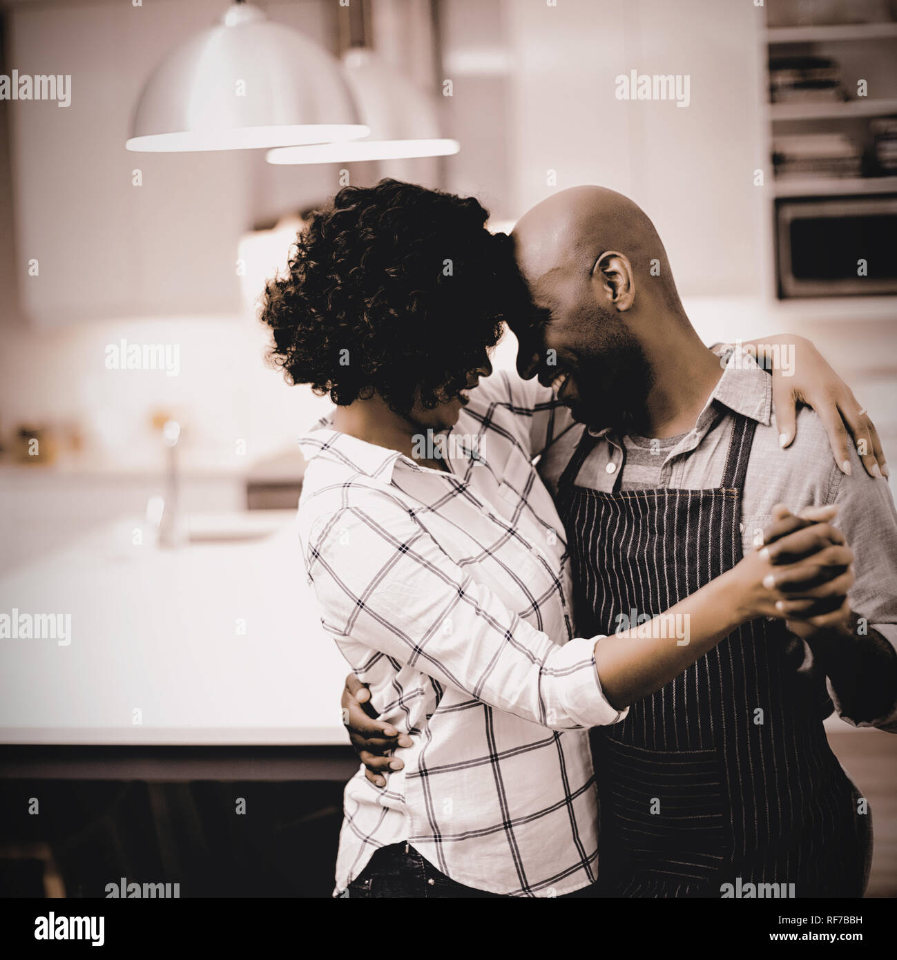Romantic couple dancing in kitchen Stock Photo - Alamy