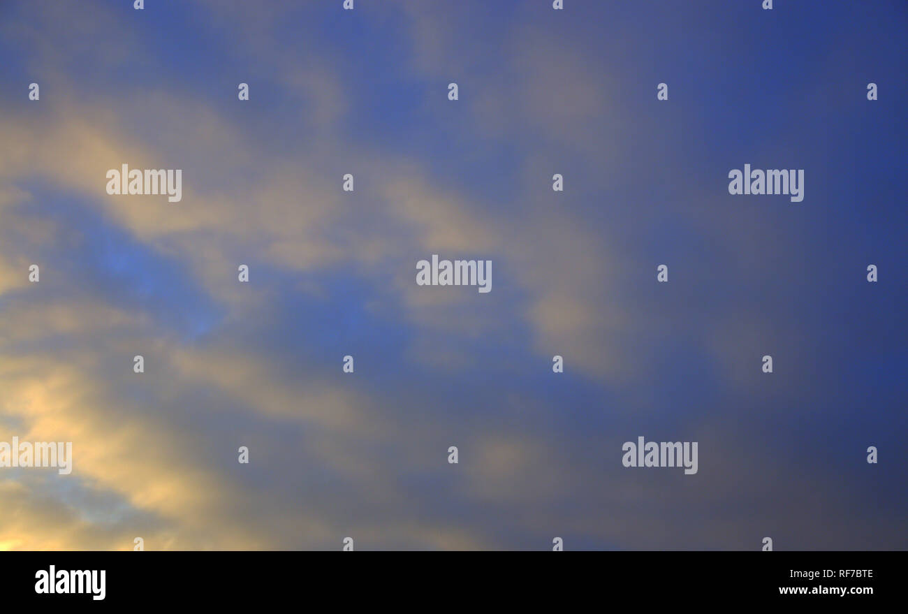 The sky, thunder clouds are illuminated from the rays of the rising sun ...