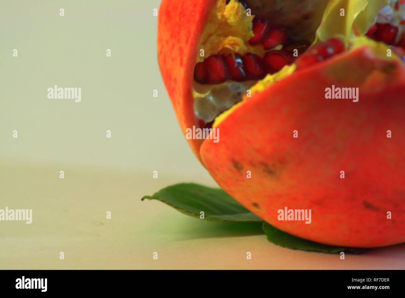 The ripe fruit of the pomegranate is cut and showing its own grains ...