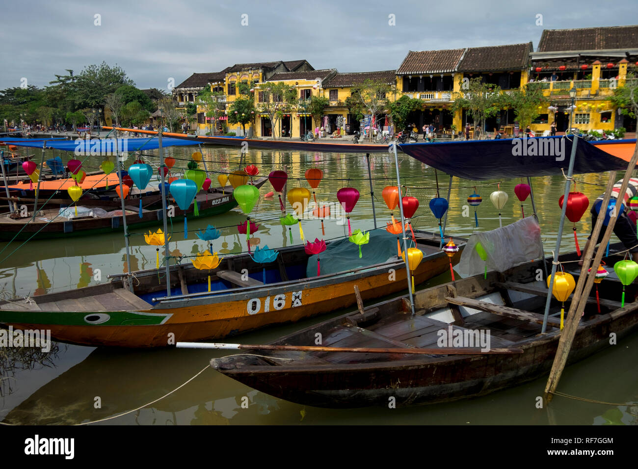 Boats tied up along the Thu Ban river in the Ancient Town section of ...