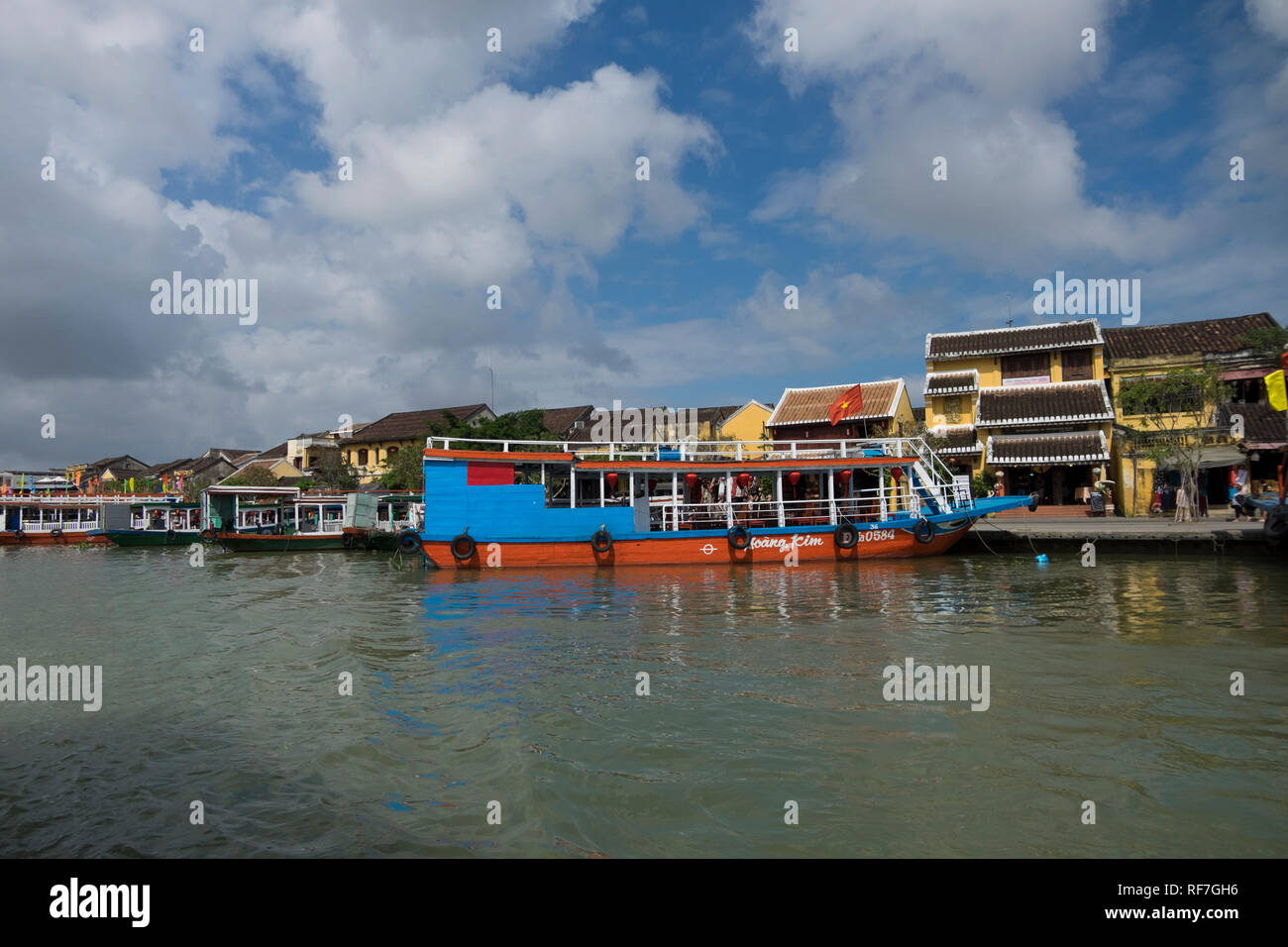 Boats tied up along the Thu Ban river in the Ancient Town section of ...