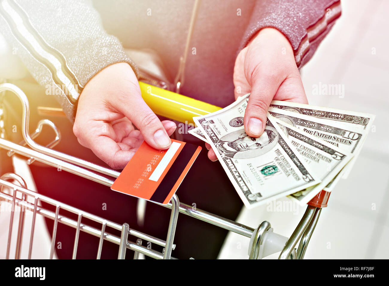 Bank card and dollar bills in the buyers hand in the store Stock Photo ...