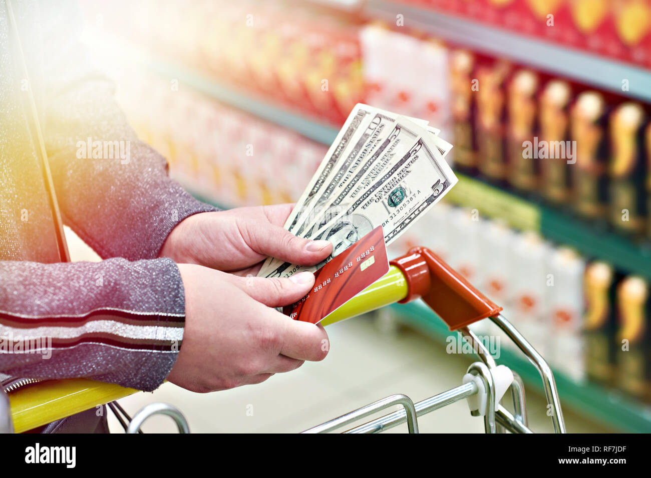 Bank card and dollar bills in the buyers hand in the store Stock Photo ...
