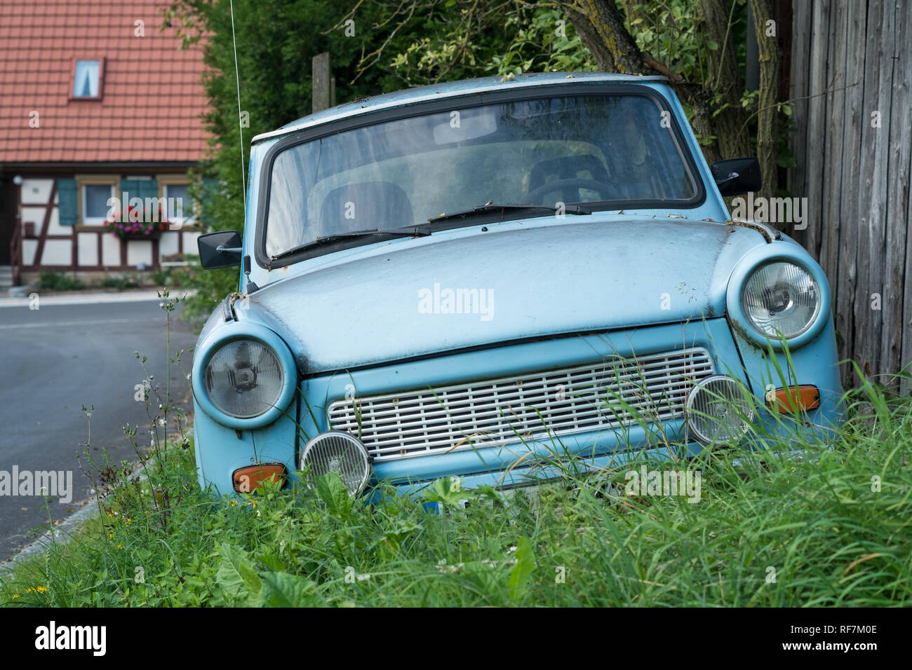 Old Eastern Europe GDR car is in the green meadow, blue oldtimer car ...