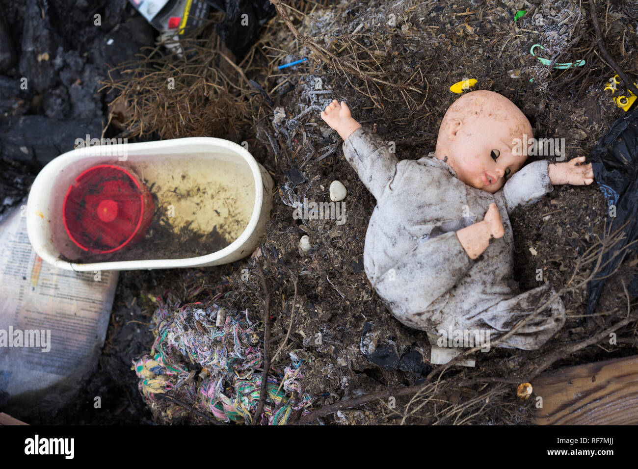 old dirty doll on a burned ground, traces of the war and fire Stock ...