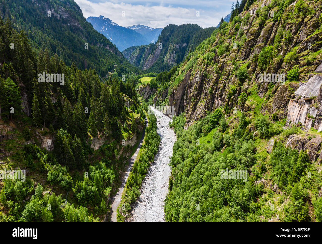 Summer Alps mountain landscape with deep ravine canyon and rapid river ...