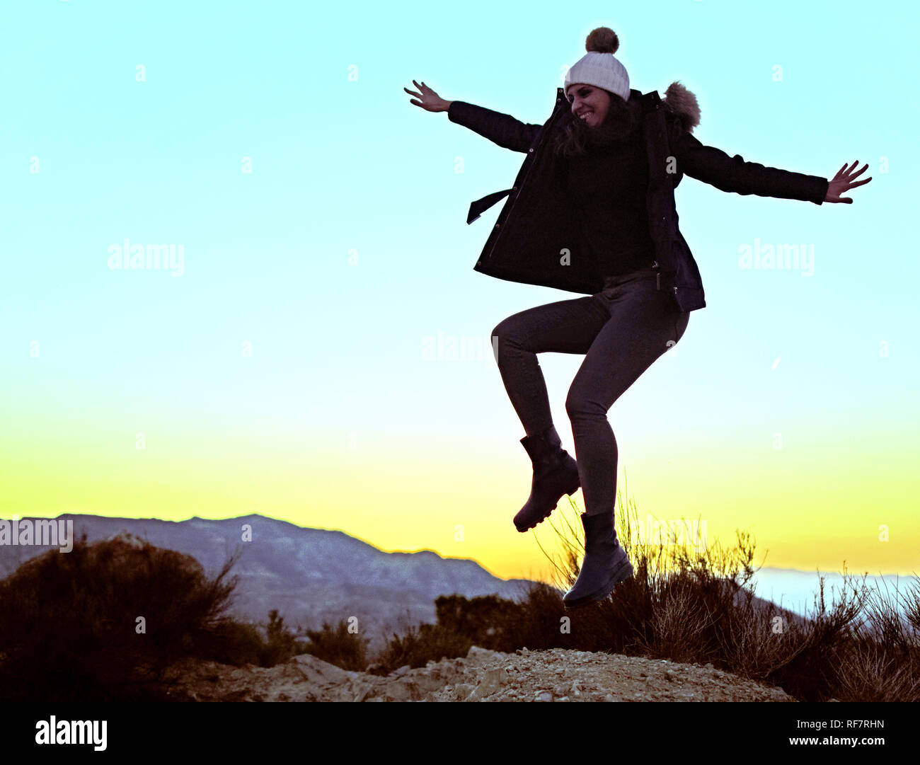 Silhouette of girl jumping in sunset Stock Photo - Alamy