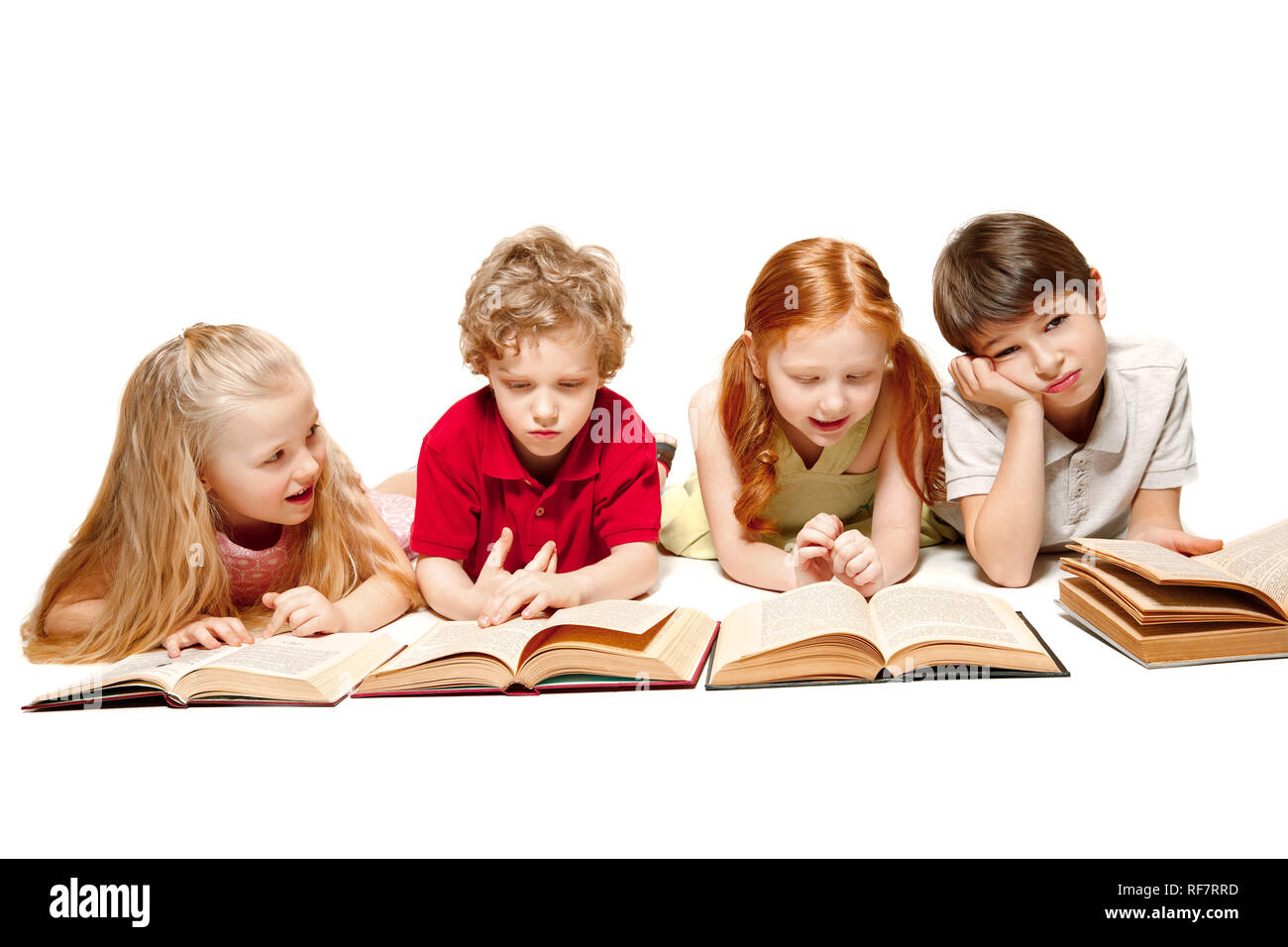 The kids boy and girls laying with books at studio, smiling, laughing ...
