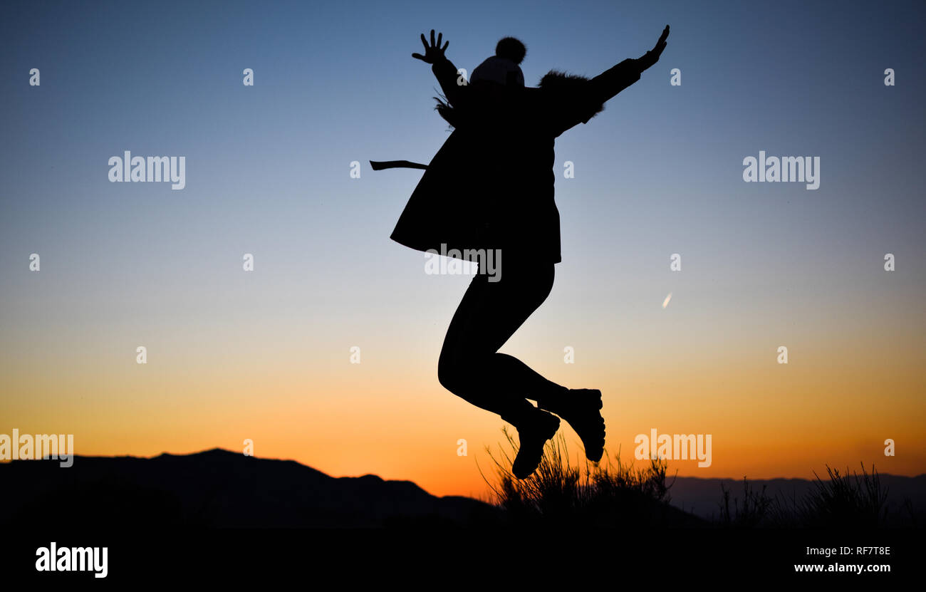 Silhouette of girl jumping against sunset Stock Photo - Alamy