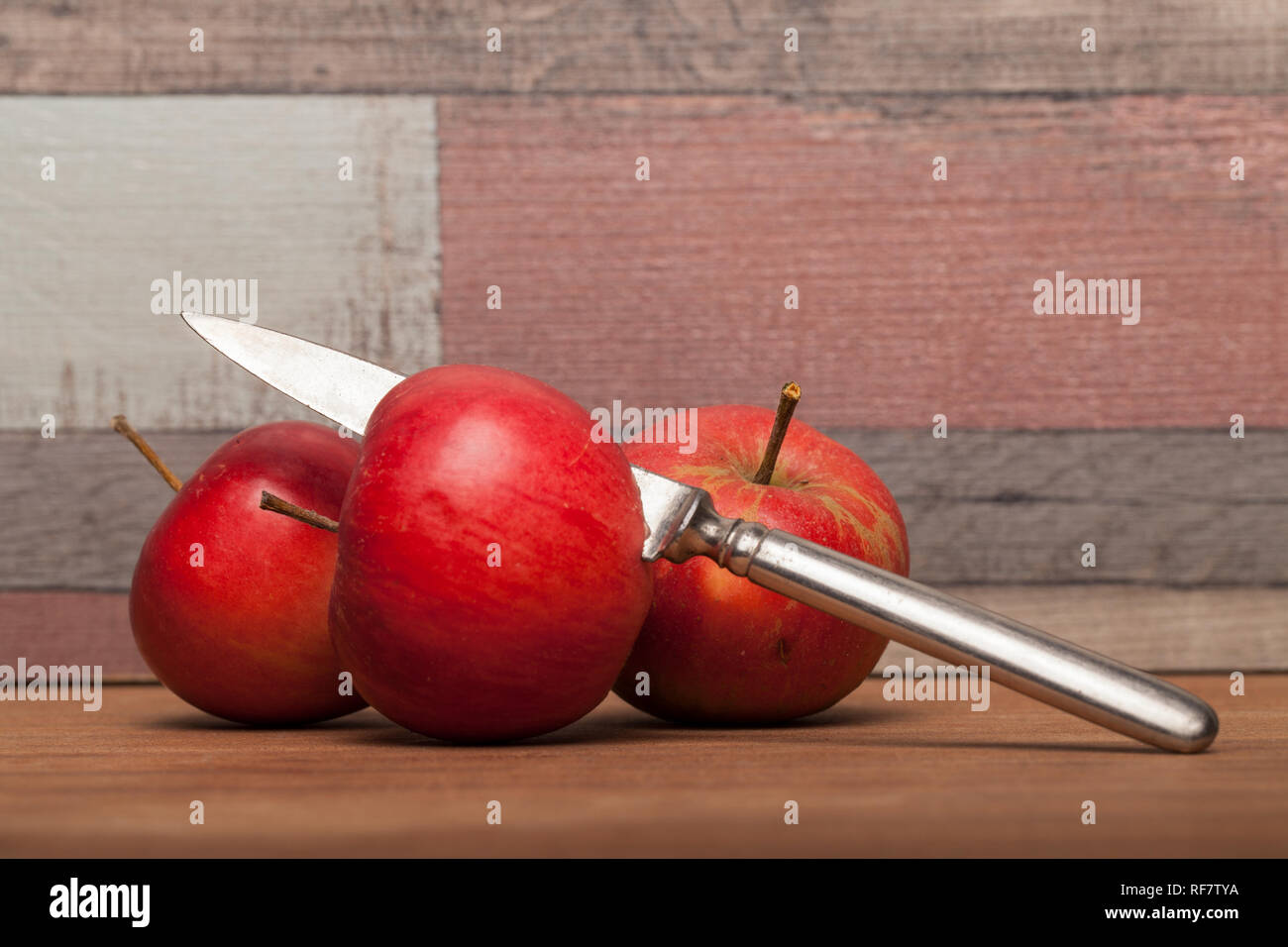 red apple on the wooden table, cut with the knife Stock Photo - Alamy