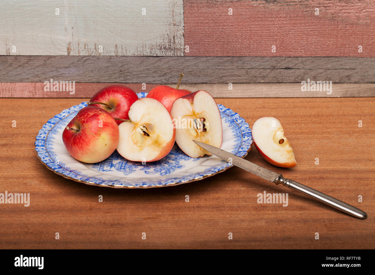 red apple on the wooden table, cut with the knife Stock Photo - Alamy