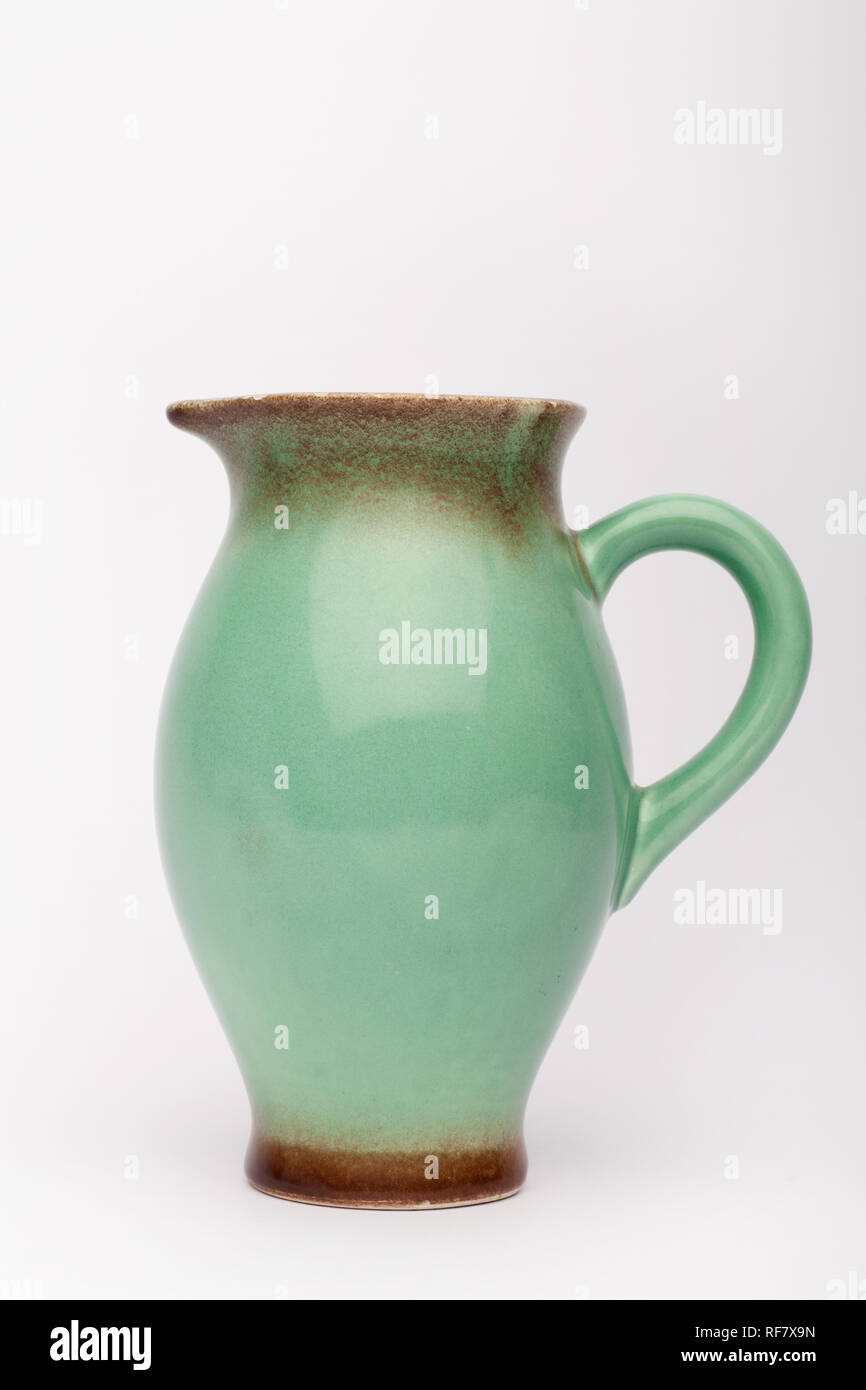 Old green milk jug on the white background, isolated Stock Photo - Alamy