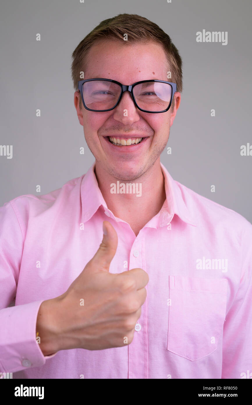 Face of young happy nerd businessman giving thumbs up Stock Photo - Alamy