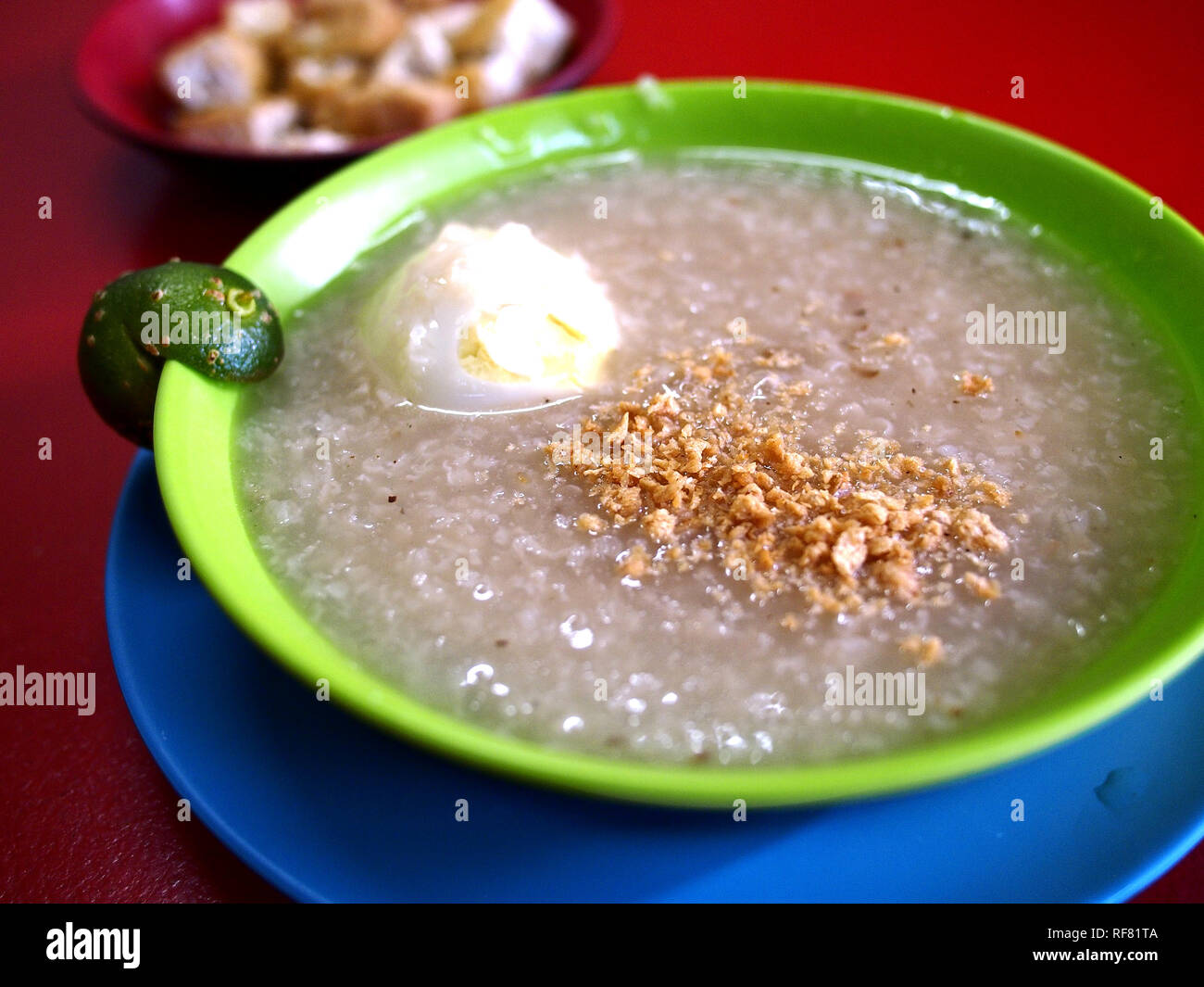 Photo of freshly cooked rice porridge with egg and pork innards ...
