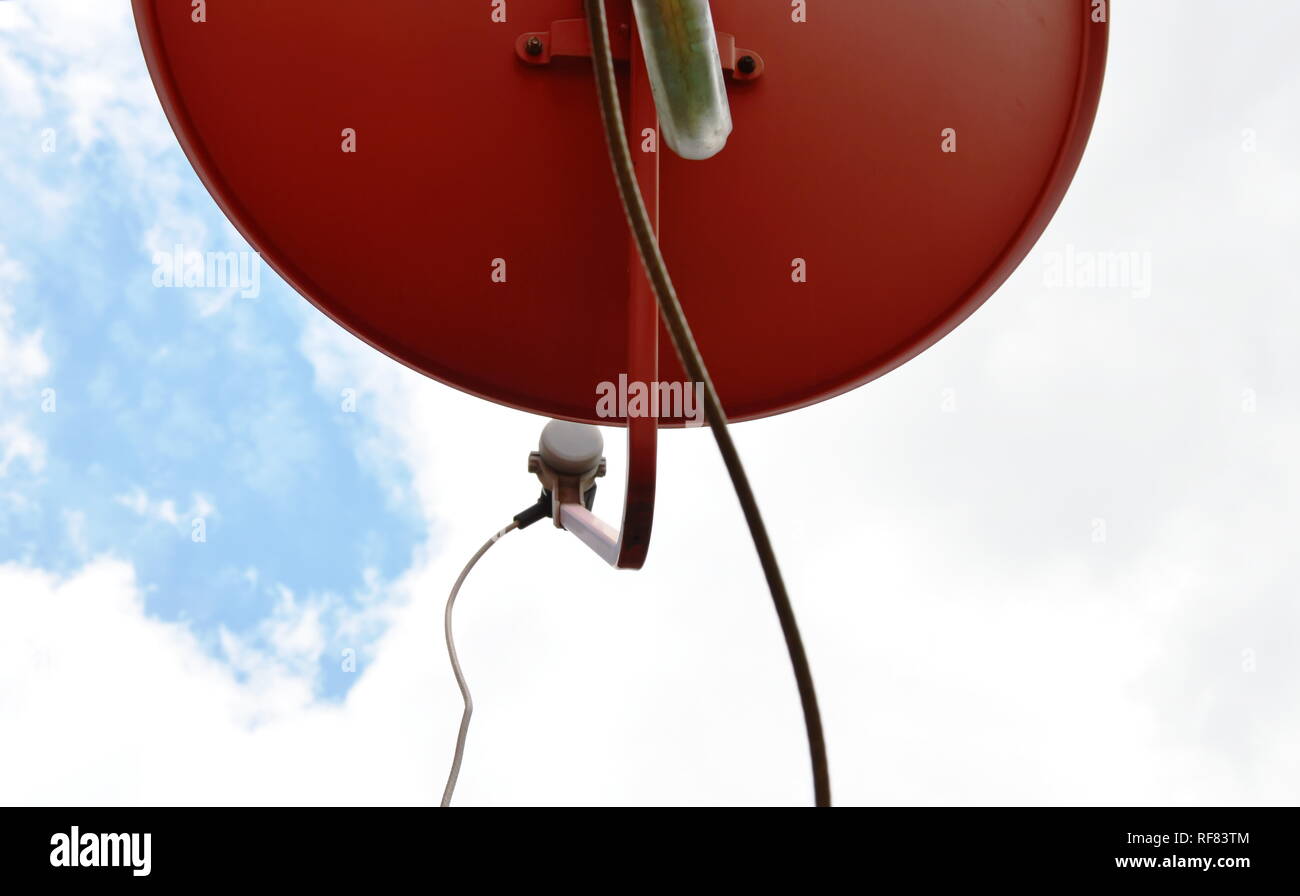 red satellite dish and sky background Stock Photo - Alamy
