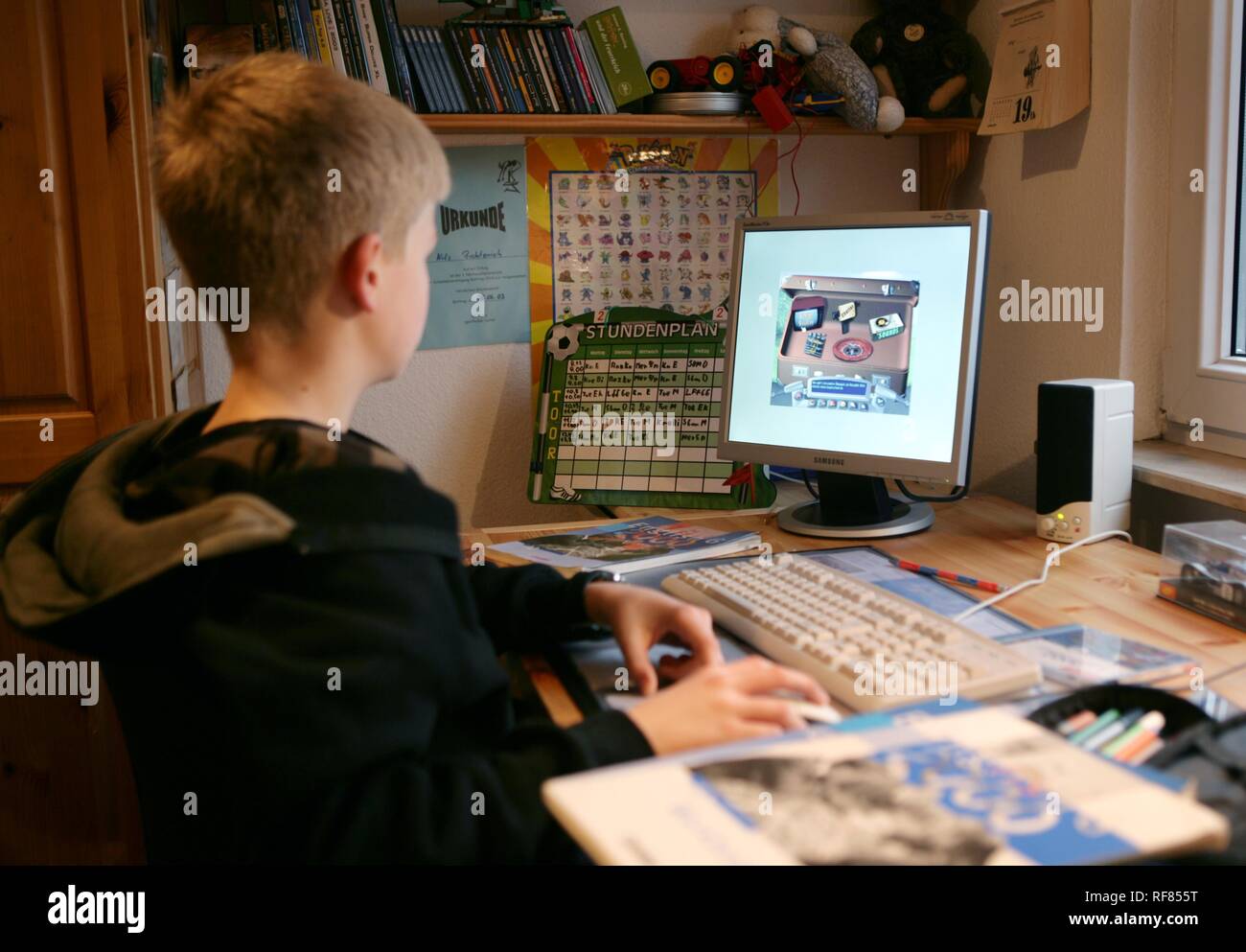 DEU, Germany: Boy, pupil is doing his homework for school Stock Photo ...