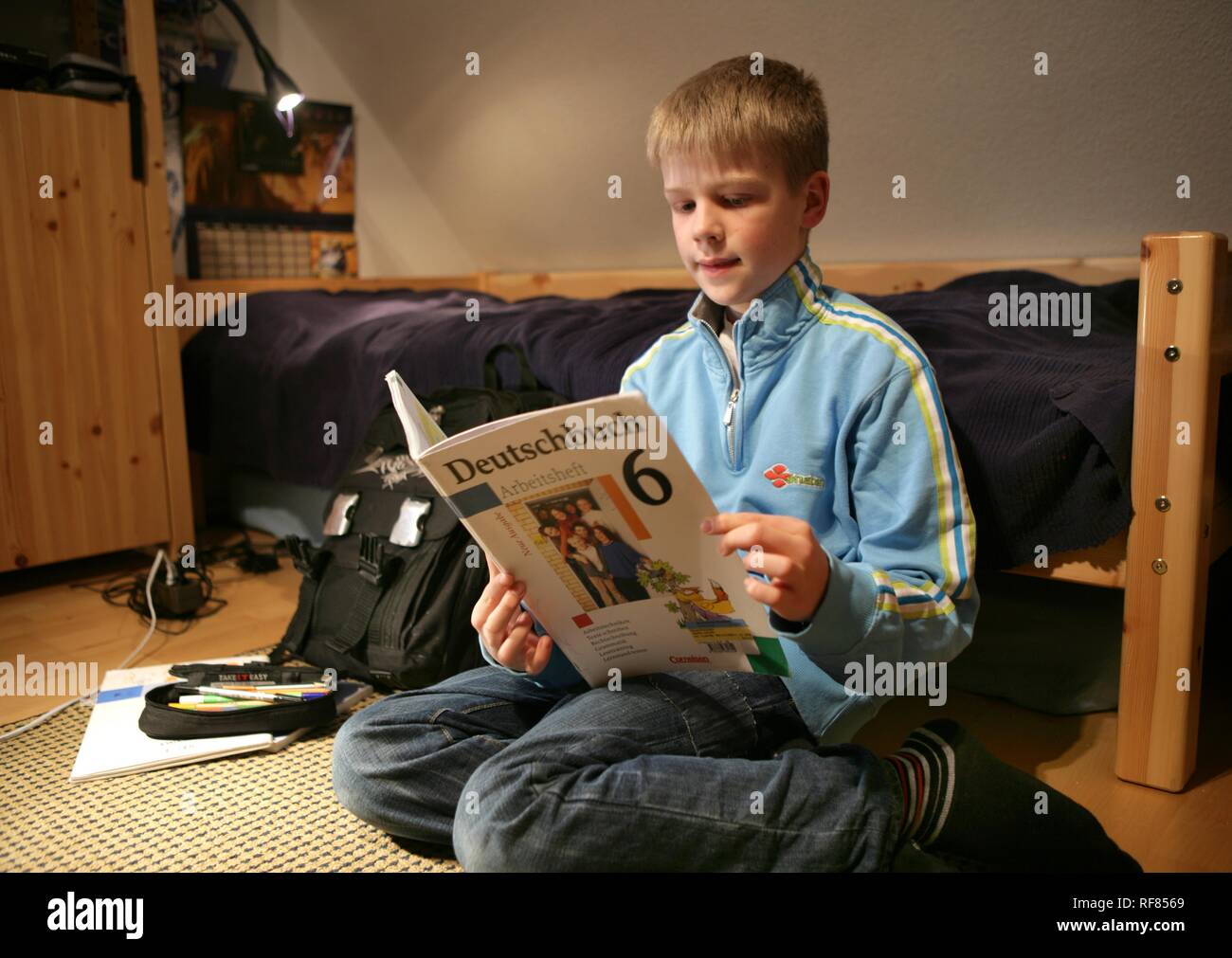 DEU, Germany: Boy, pupil is doing his homework for school, German ...