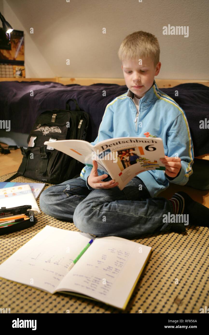 DEU, Germany: Boy, pupil is doing his homework for school, German ...