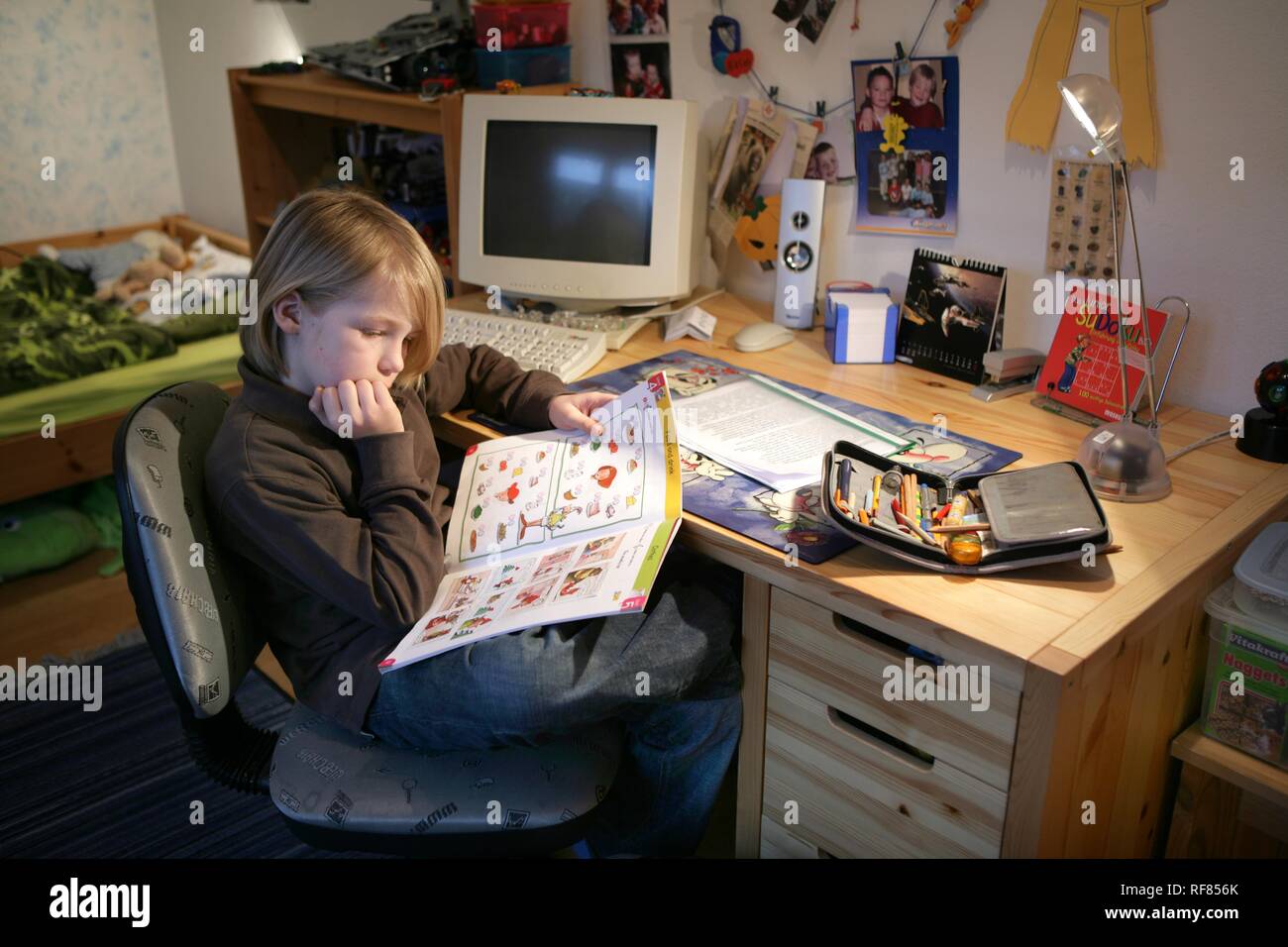 DEU, Germany: Young boy, student is learning for school, at home ...